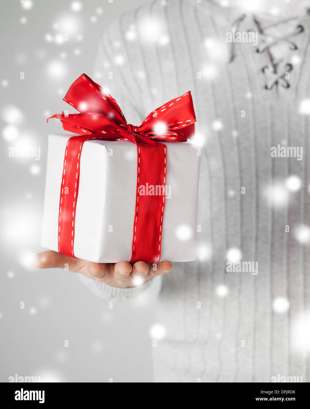 Hand is holding a gift box with a red ribbon hi-res stock photography ...