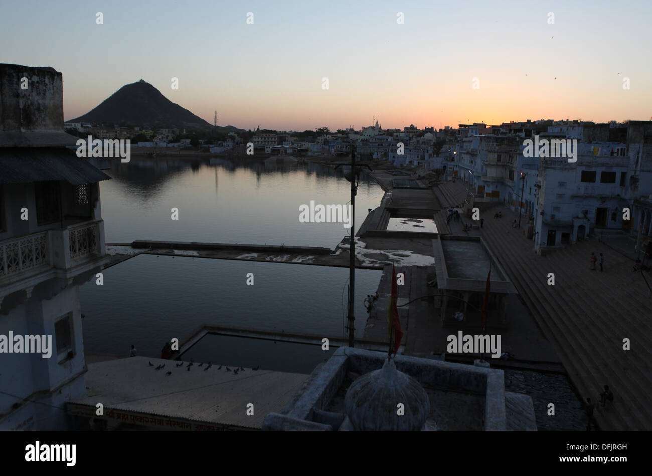 View from the city of Pushkar over ghats and the holy lake after sunset ...