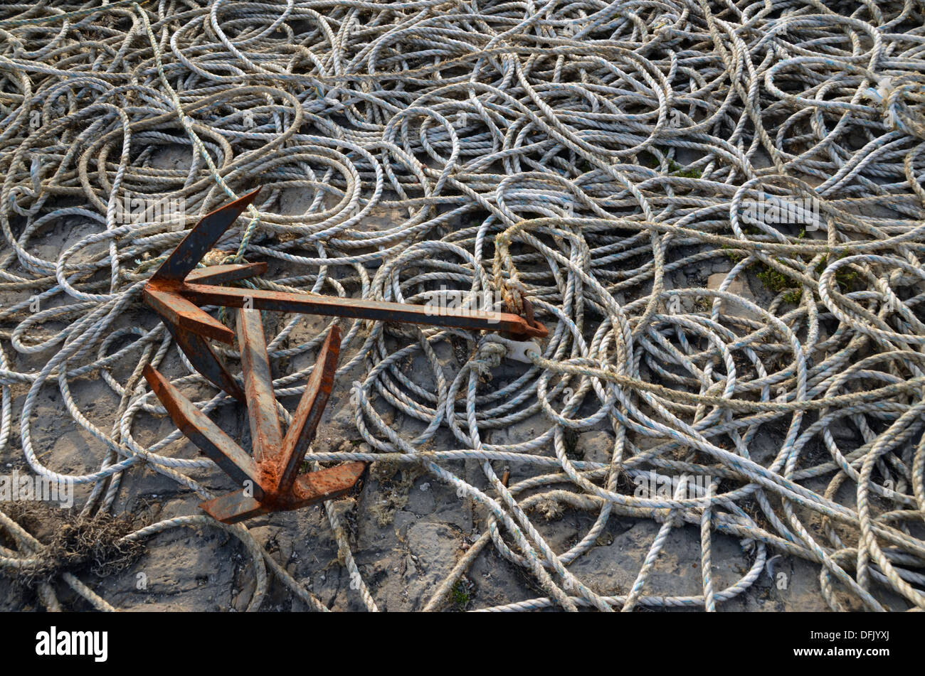 Fishing net ropes and 2 anchors on a quay in the harbour of Grandcamp ...