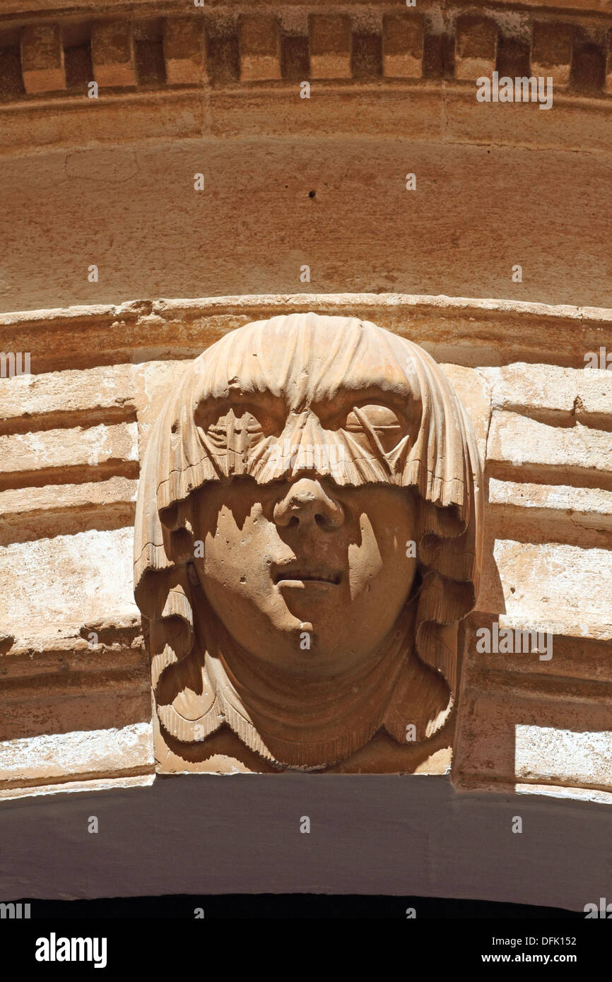 Sculpture of a womans head with a blindfold, above a doorway in Carrer ...