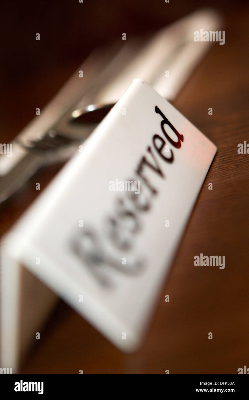 Reserved sign on table in restaurant Stock Photo - Alamy