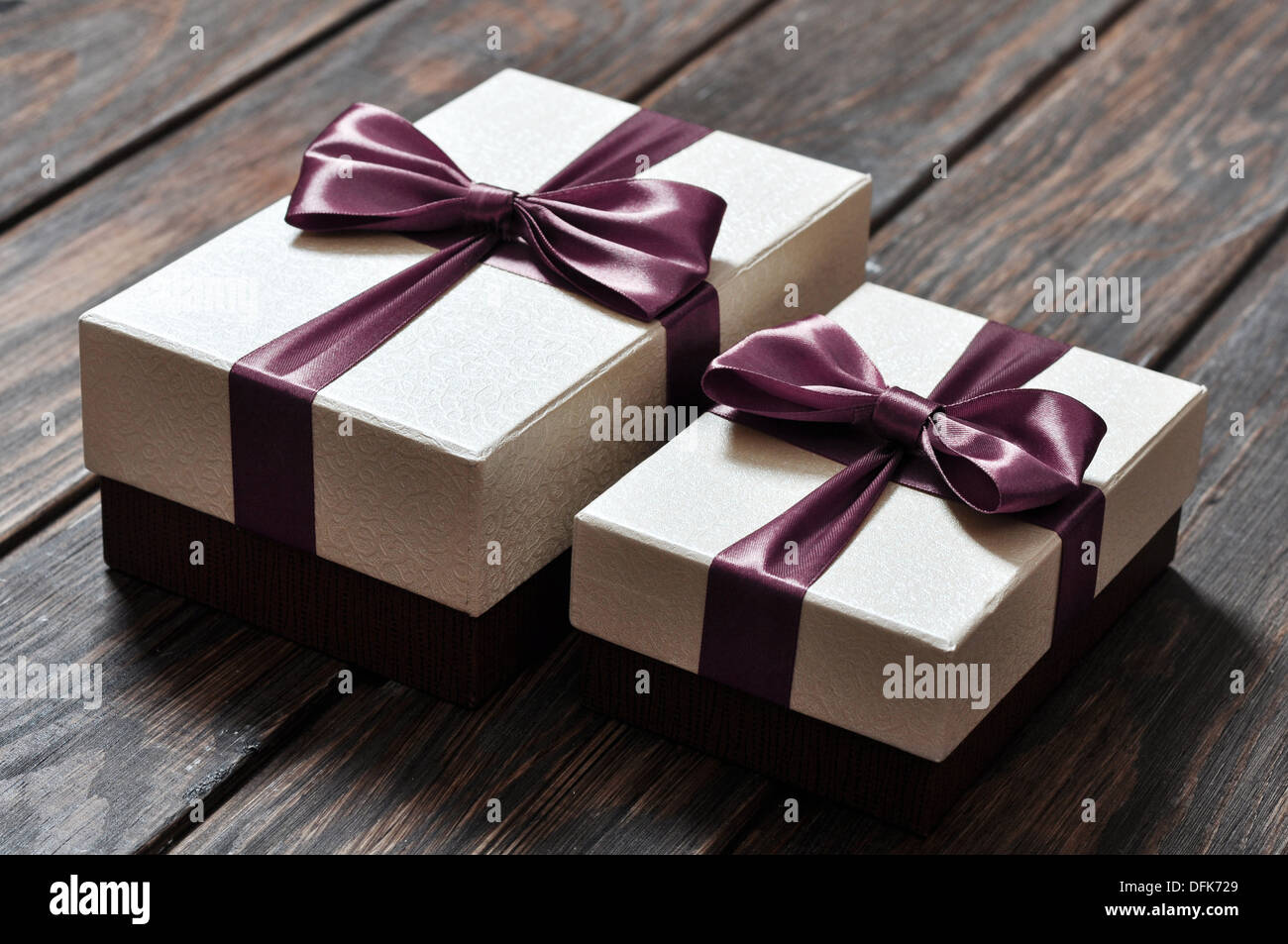 two elegant gift boxes on a wooden background Stock Photo - Alamy