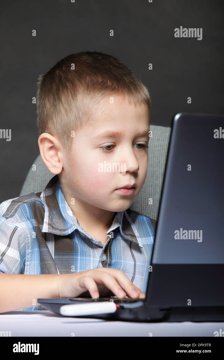 Computer addiction child boy with laptop notebook black background ...