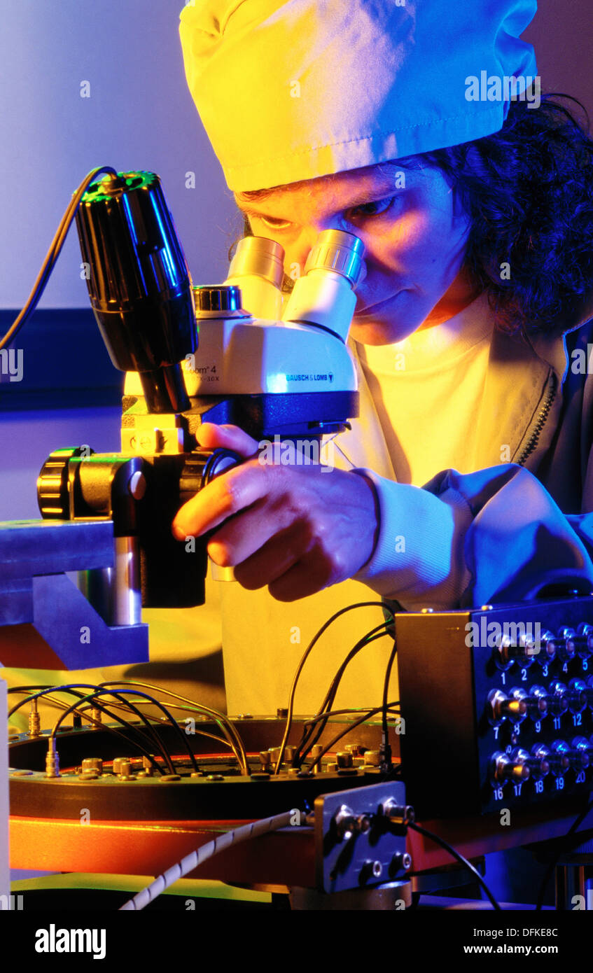 Technician using microscope Stock Photo - Alamy