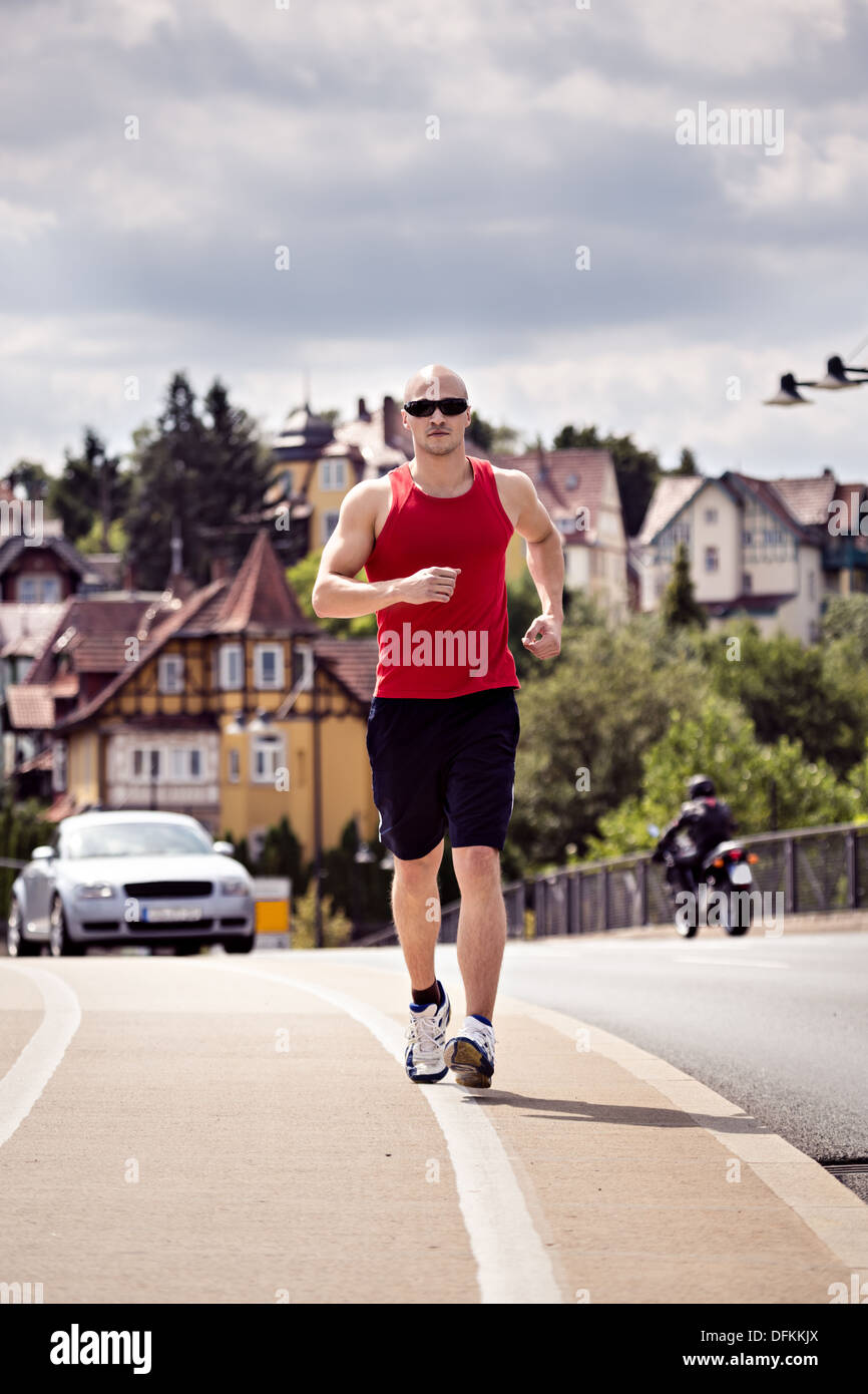Adult man running in city hi-res stock photography and images - Alamy