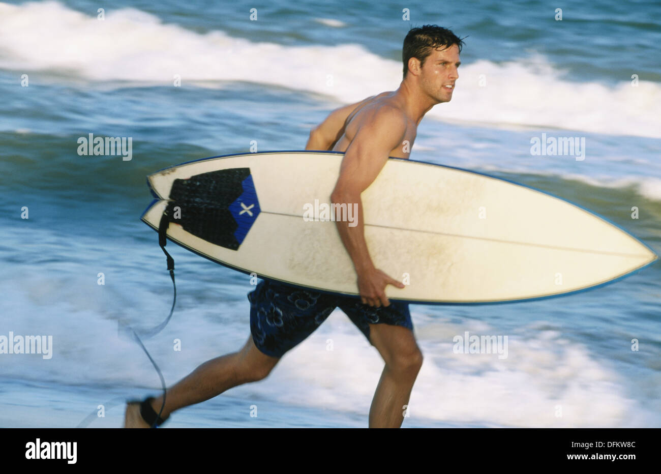 Running carrying surf board surfboard hi-res stock photography and ...