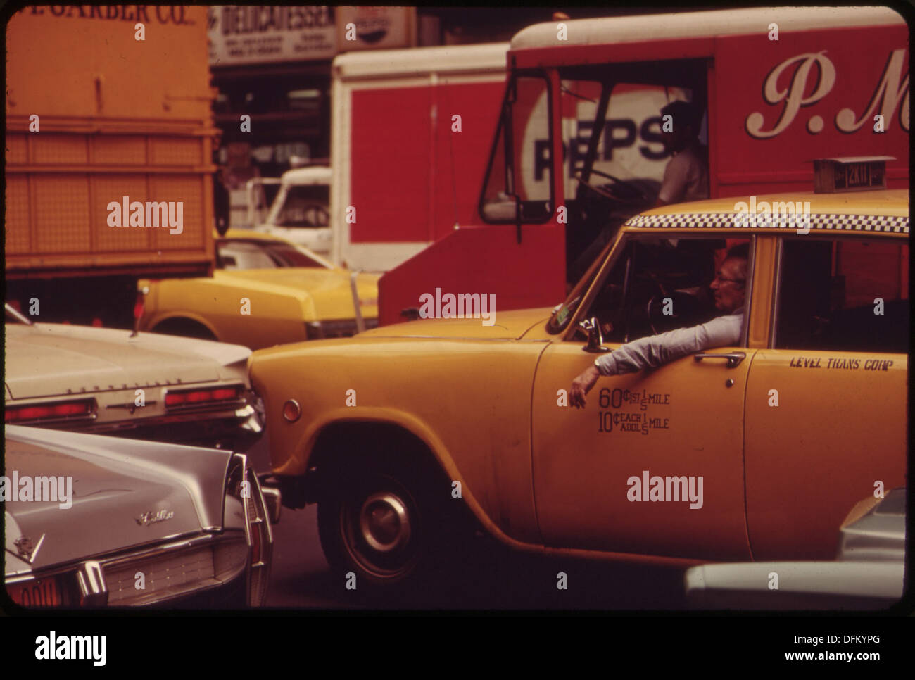 This image depicts a busy scene of traffic in a midtown area, with ...