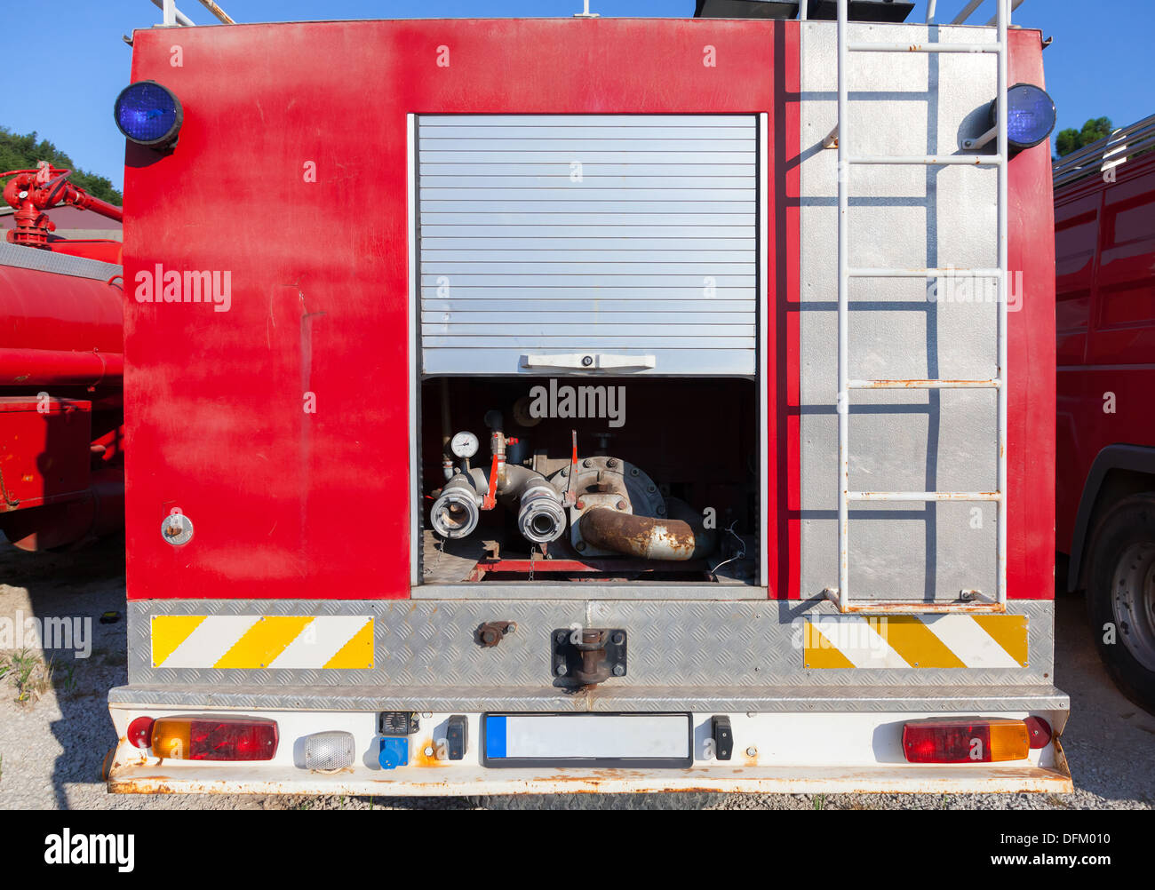 The rear of fire truck with water pump equipment Stock Photo - Alamy