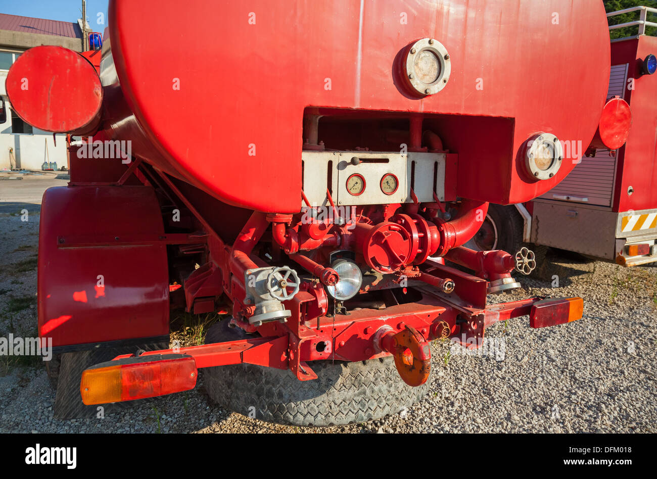 The rear of old red fire truck with water pump equipment Stock Photo ...