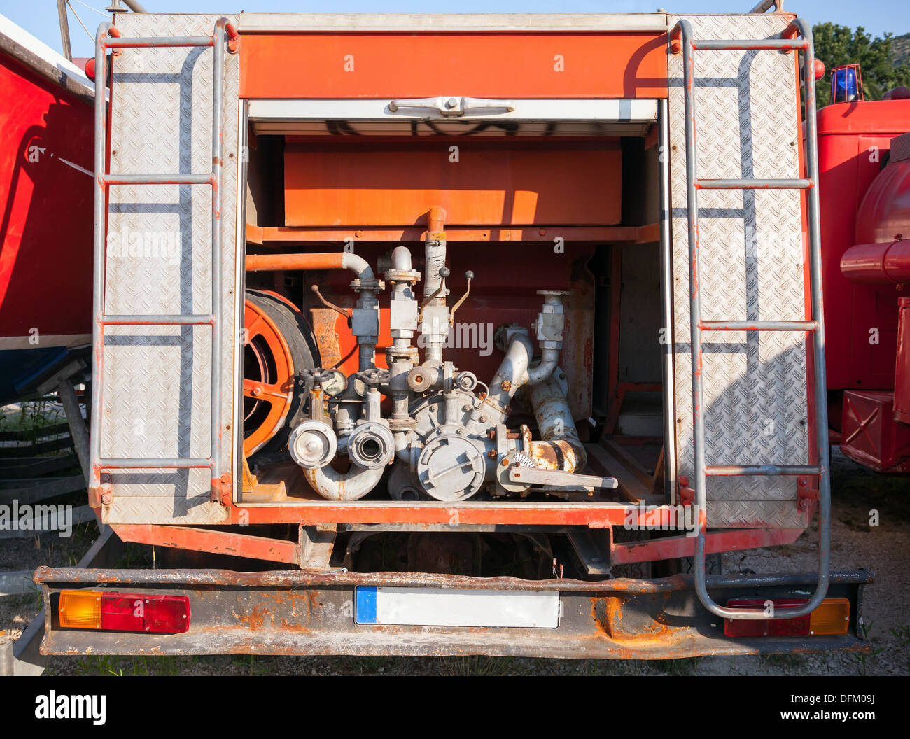 The rear of the red fire truck with water pump equipment Stock Photo ...