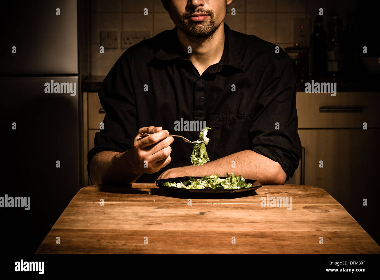 Young man having dinner at home Stock Photo - Alamy