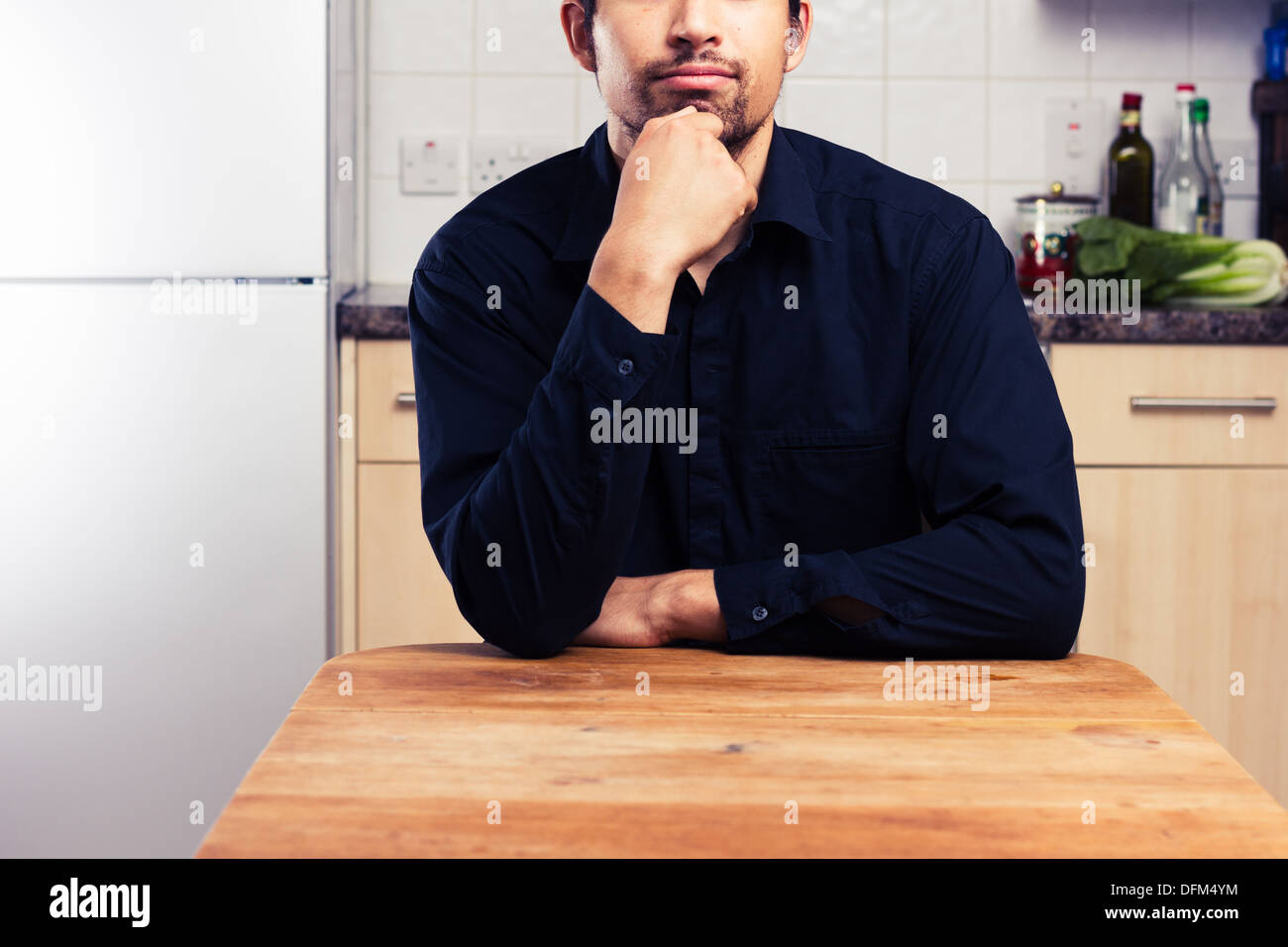 Young thinking man in kitchen hi-res stock photography and images - Alamy