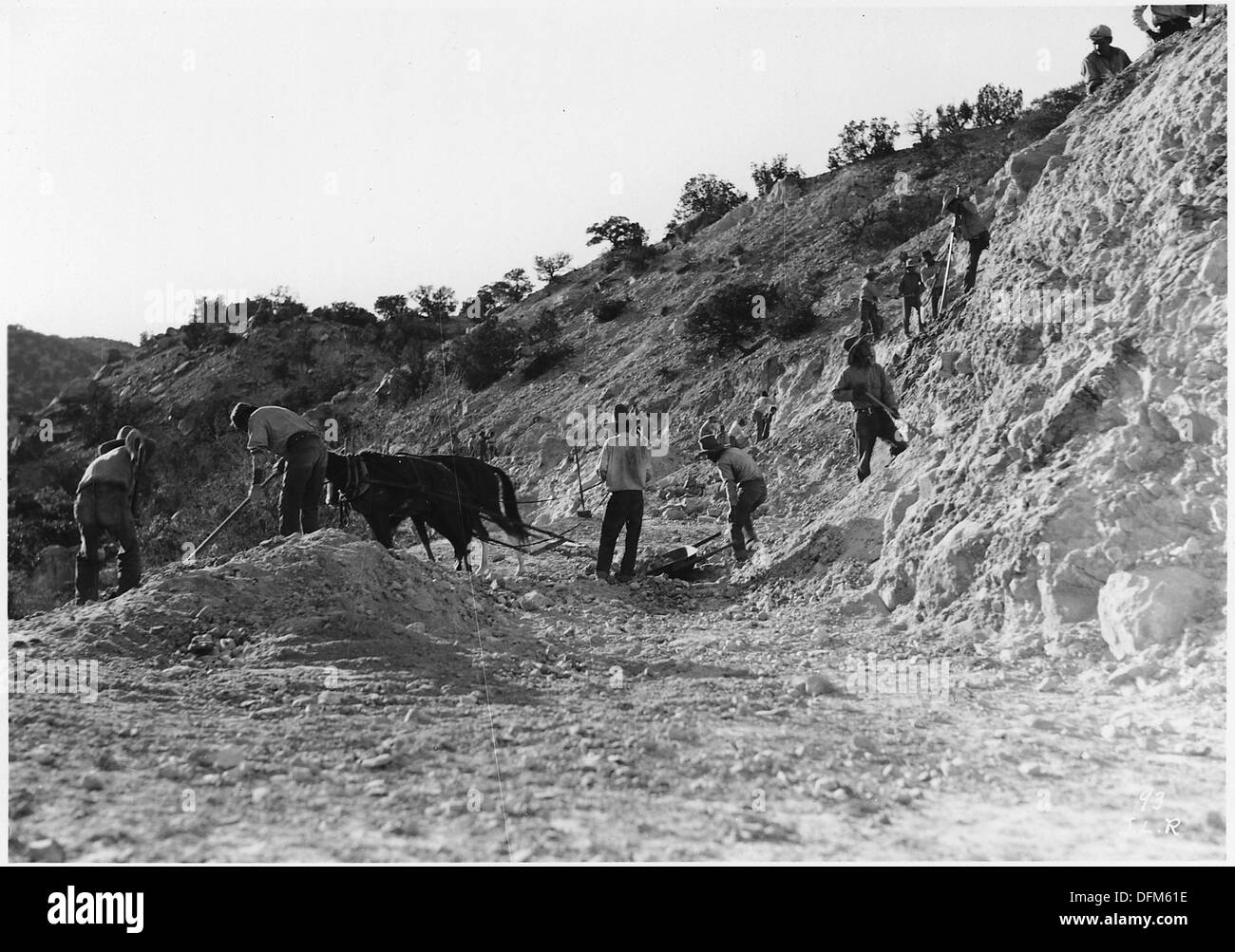 Navajo workers are pictured constructing a road through Tohatchi Canyon ...