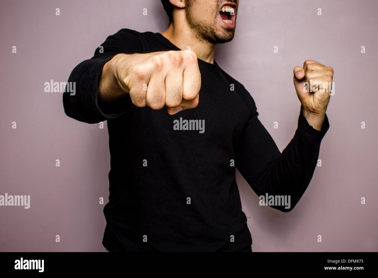Angry young man throwing punches Stock Photo - Alamy