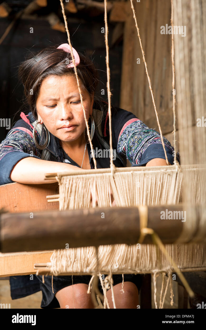 Minority group Black Hmong woman showing how to weaving traditional ...