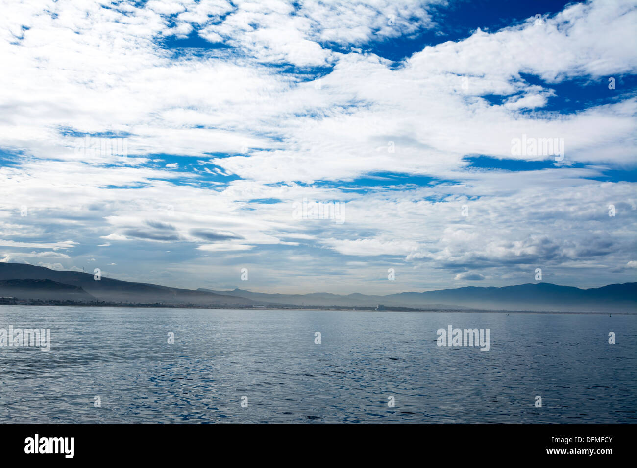 A beautiful, puffy white cloud covered sky with fog line during an ...