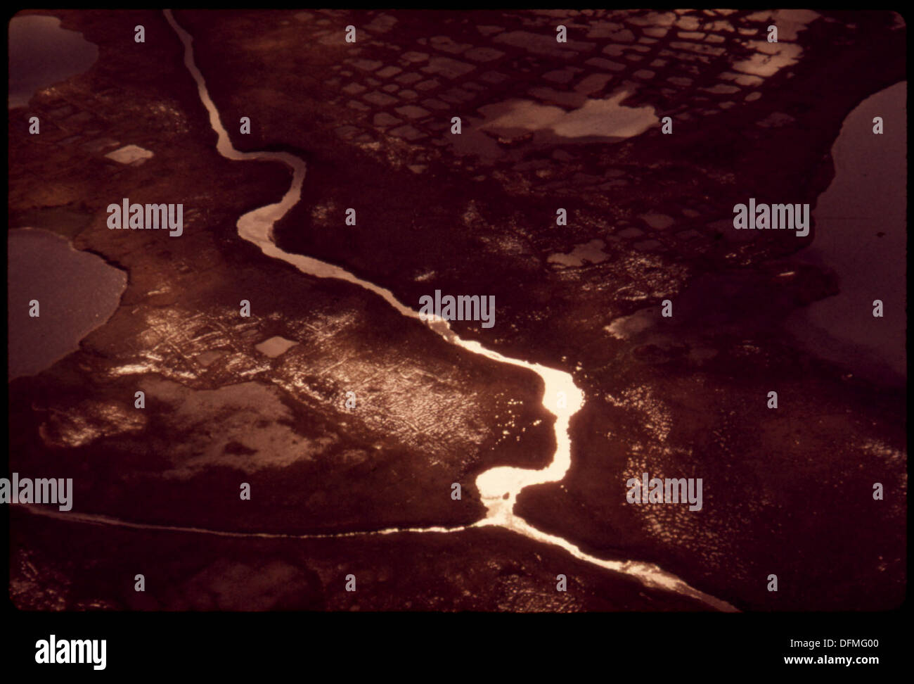 The photograph shows patterned ground, created by large ice formations ...