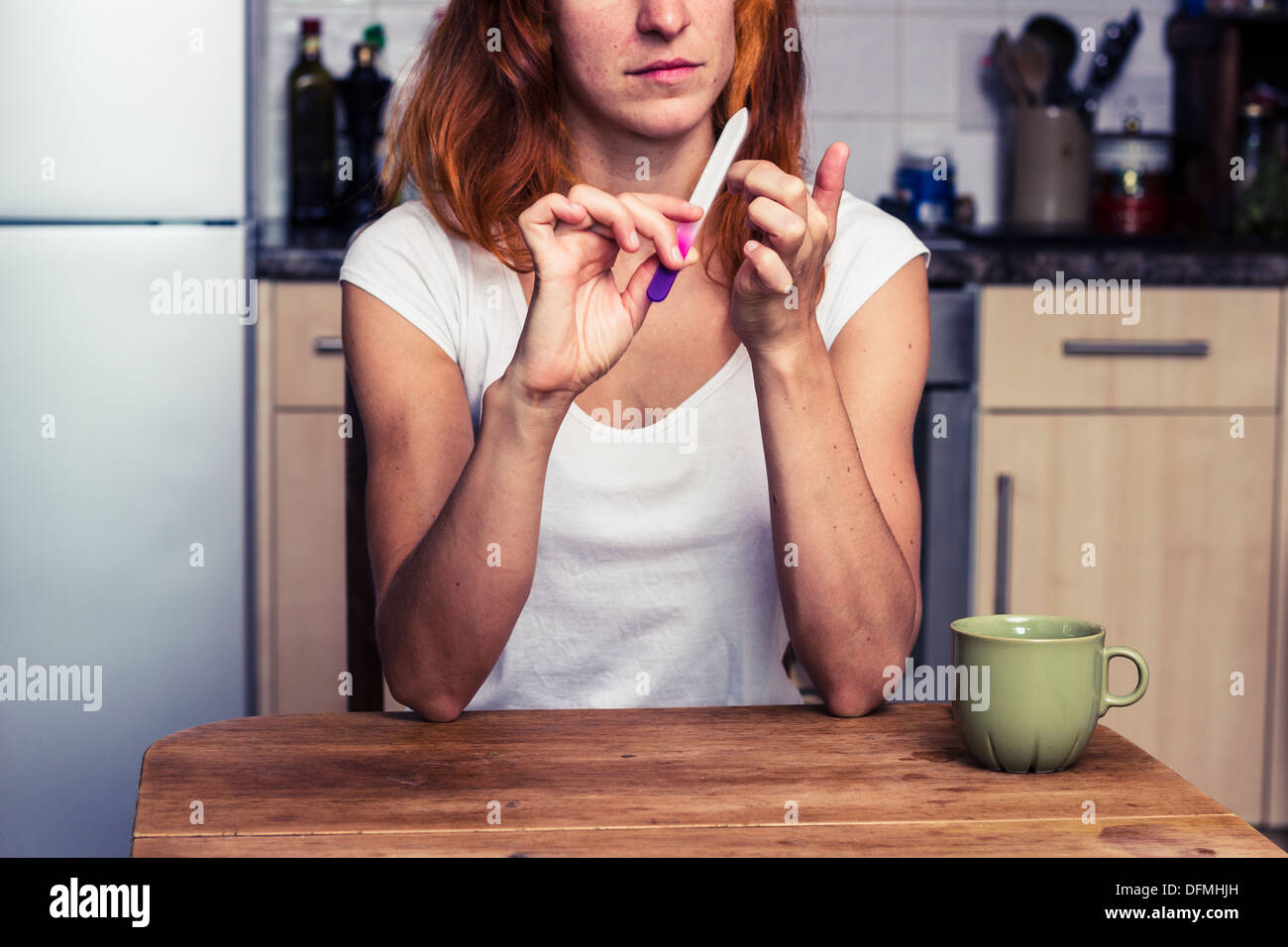 Woman filing her nails hi-res stock photography and images - Alamy