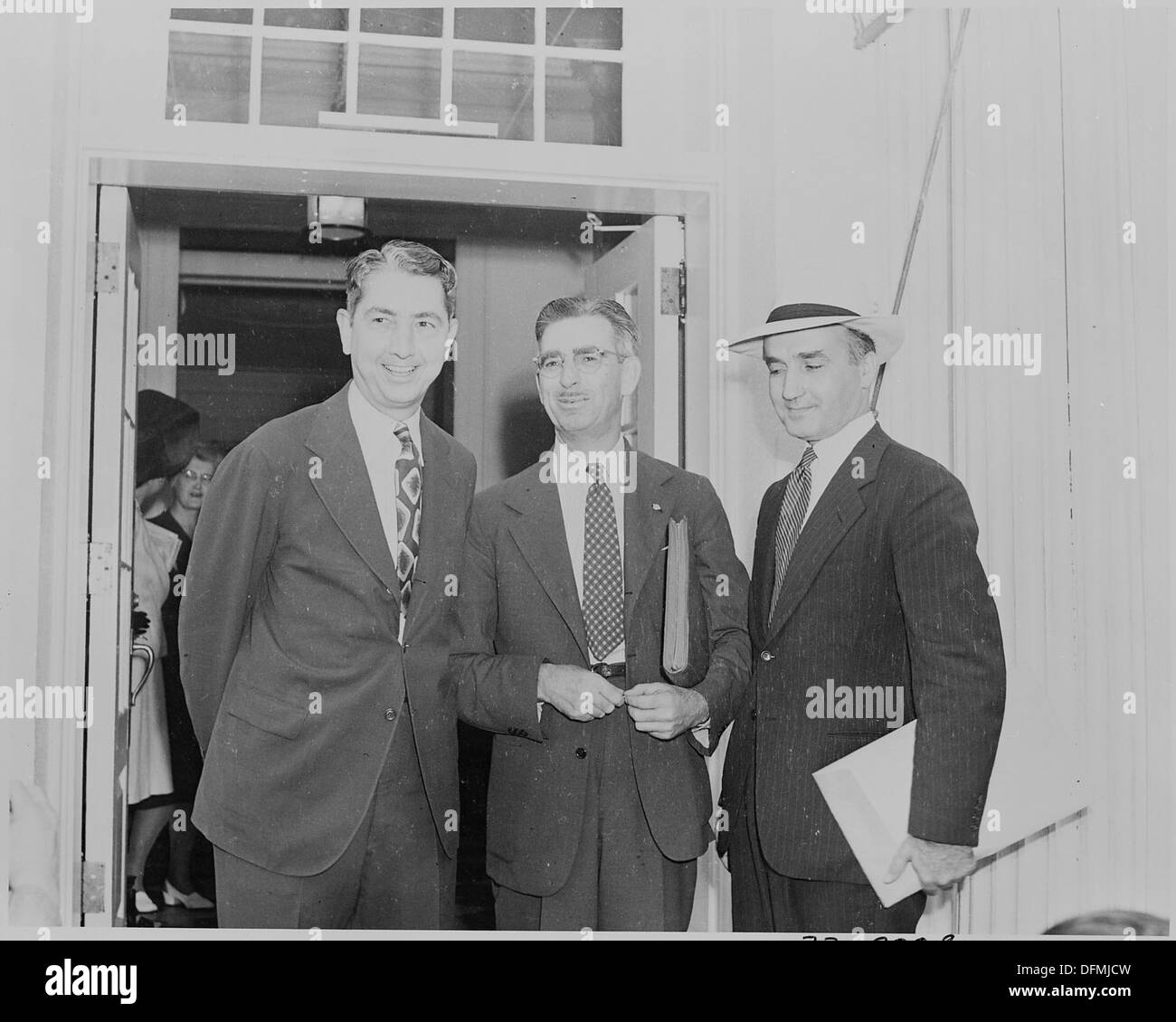 This photograph shows Attorney General Tom Clark with two unidentified ...