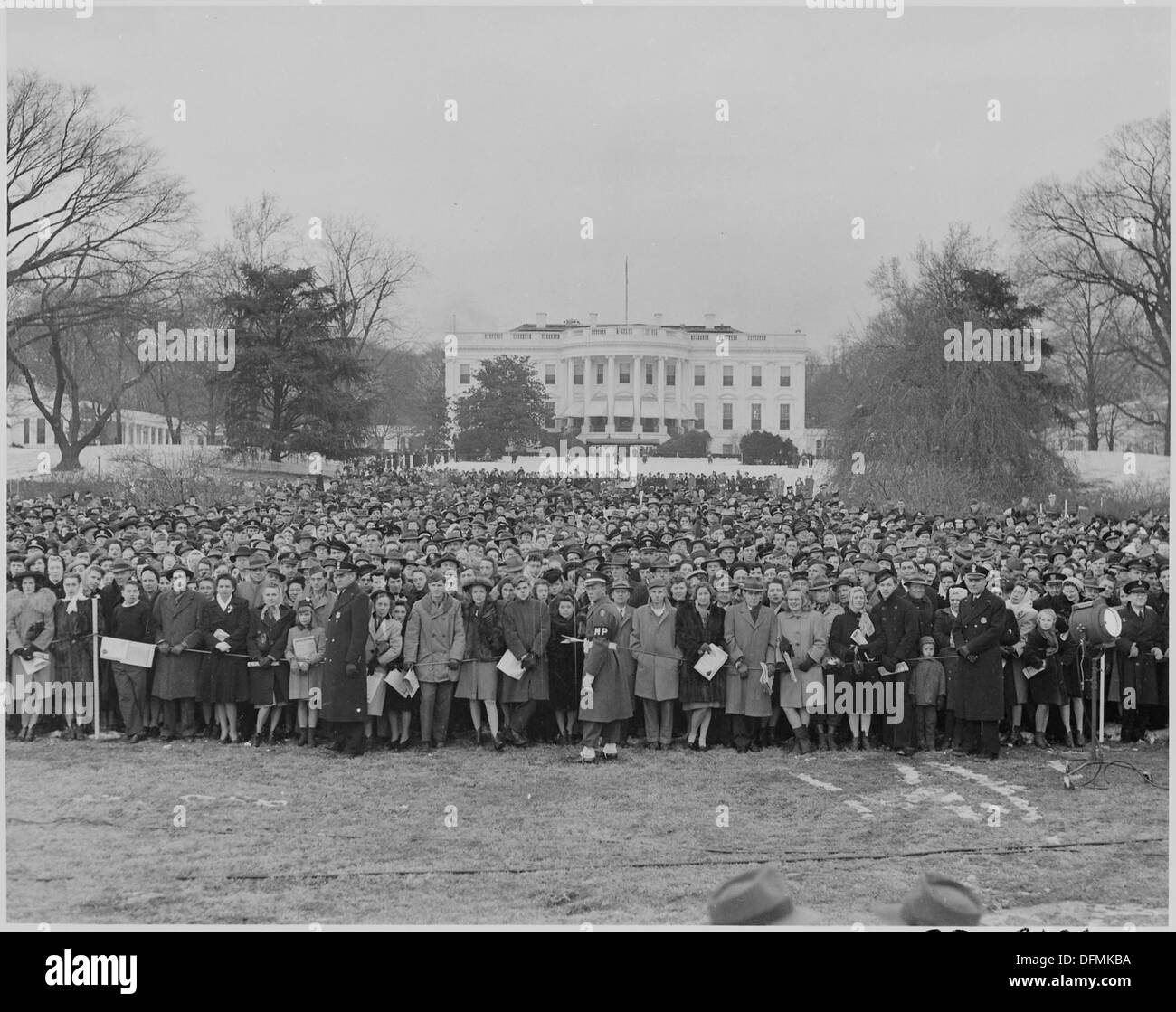 Photograph of a large crowd of spectators assembled on the White House ...