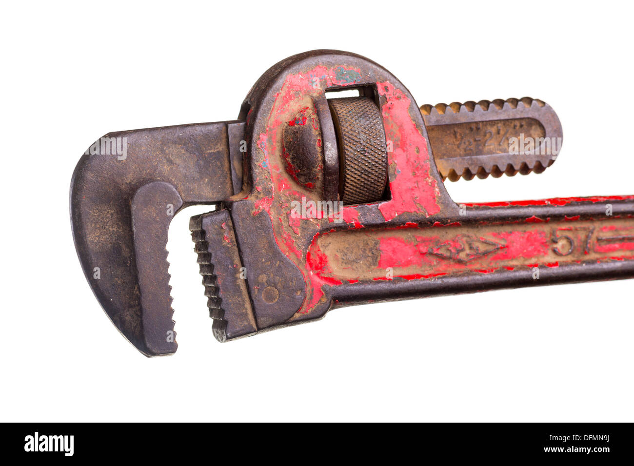 An old beat-up plumber’s wrench which has its red paint partially ...