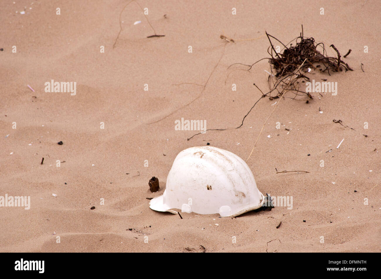 White construction hard hat on sand Stock Photo - Alamy