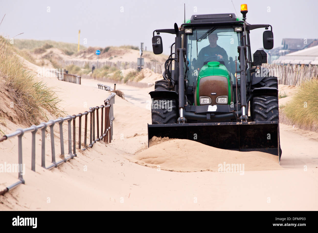 Tractor moving sand around Crosby beach Stock Photo - Alamy