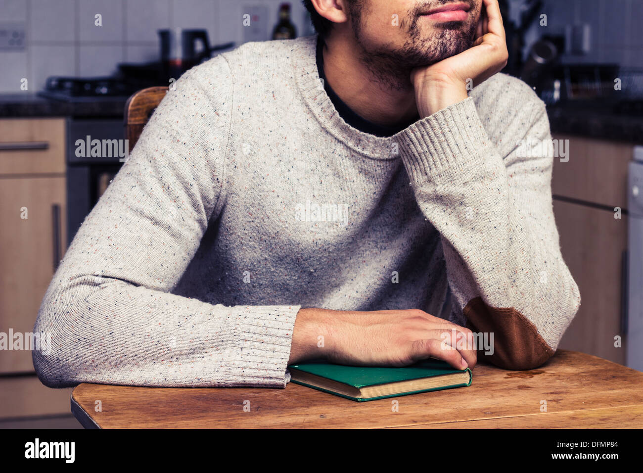 Happy man daydreaming in kitchen Stock Photo - Alamy