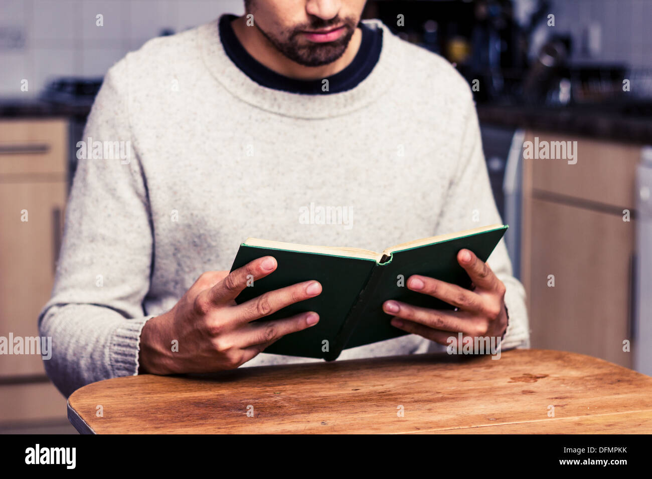 Black man reading book home hi-res stock photography and images - Alamy