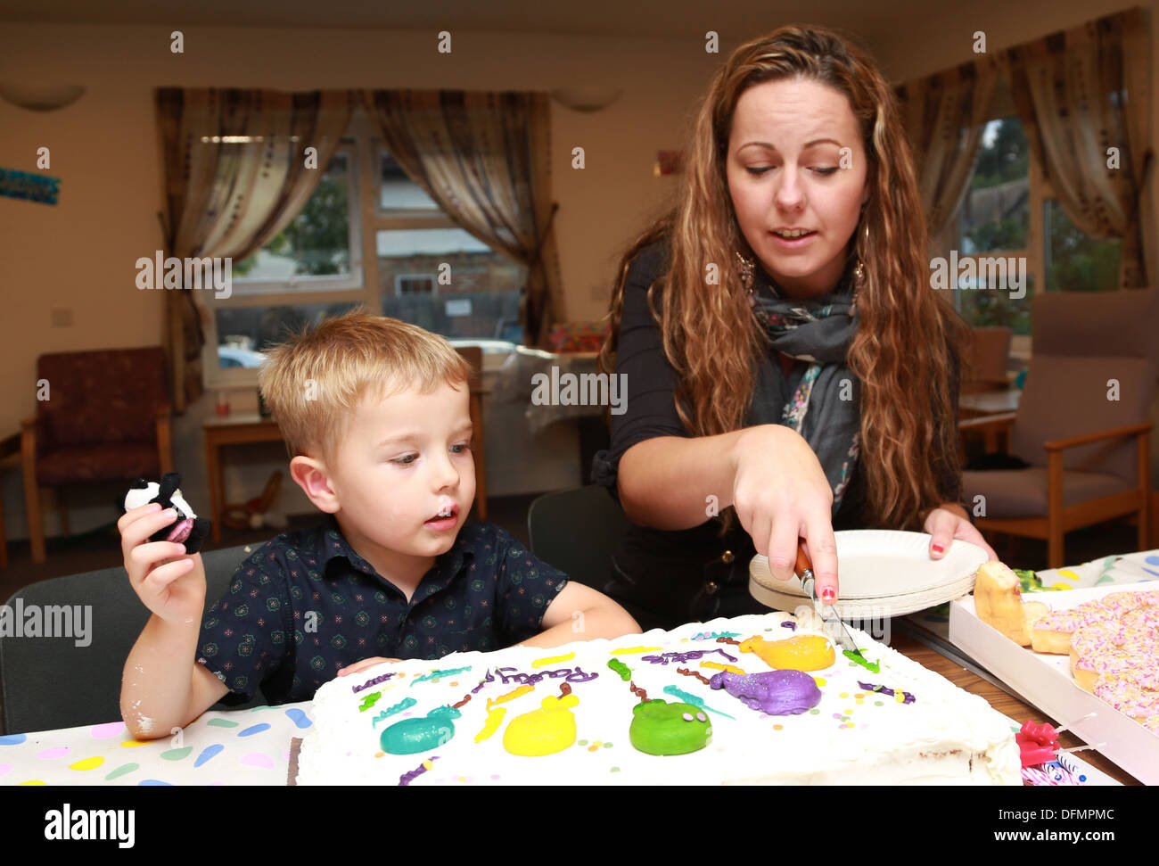 Child cutting birthday cake hi-res stock photography and images - Alamy
