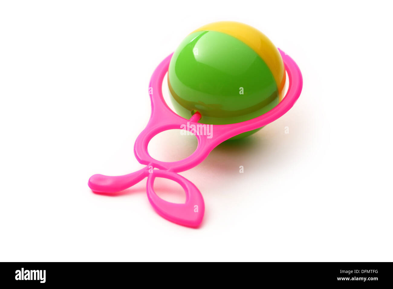 Colourful rattle on white background Stock Photo - Alamy