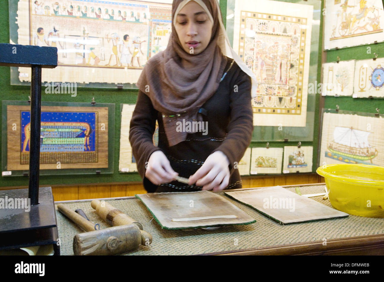 Woman showing the process to make papyrus for paintings. Cairo. Egypt ...
