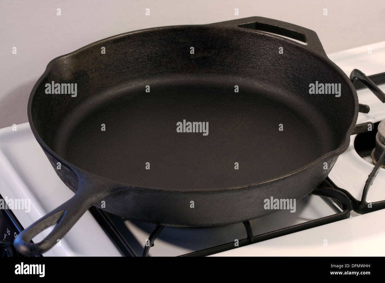 Empty 12" Heavy Cast Iron Skillet on gas burning stovetop Stock Photo ...