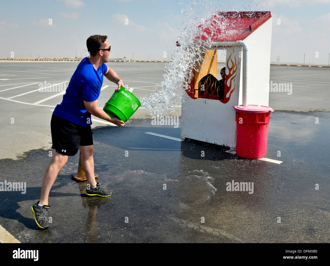 Capt. Jordan Tribble dowses 1st Lt. Susan Harrington “trapped by fire ...