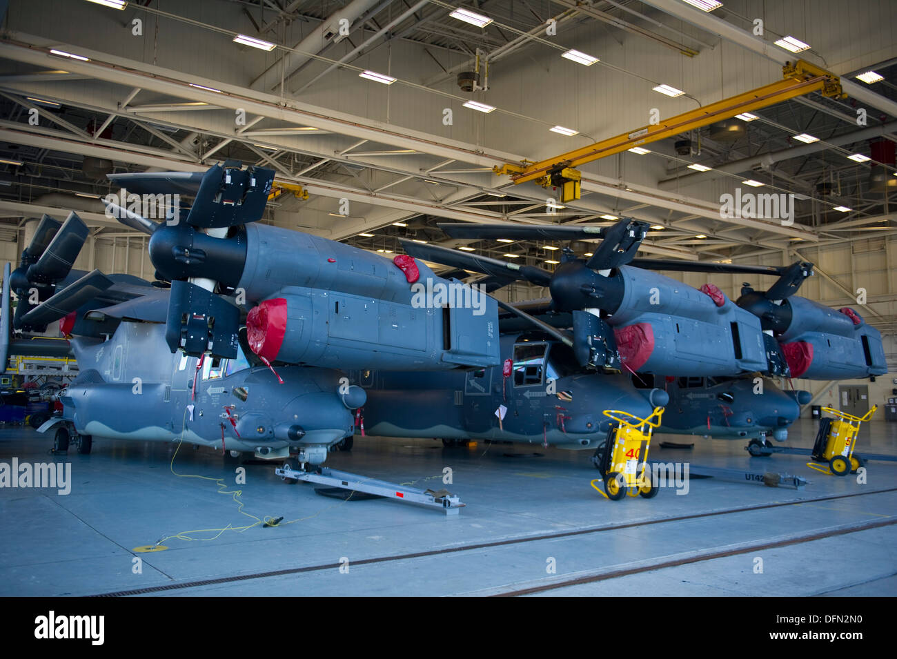 U.S. Air Force CV-22 Ospreys sit folded in a hangar at Hurlburt Field ...