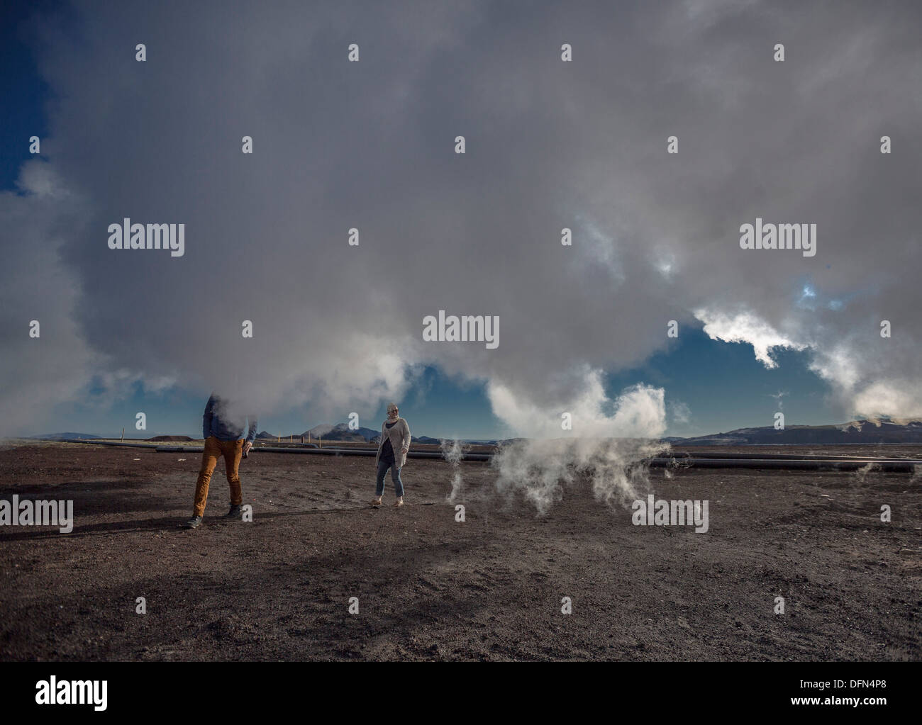 Couple walking under Geothermal Steam, Namaskard- Geothermal Volcanic ...