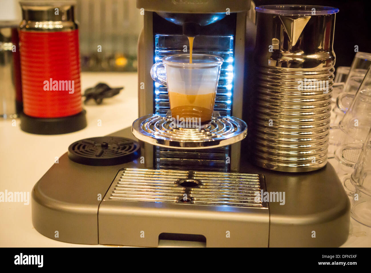 A Nespresso brand single-shot coffee brewer pours an espresso at a ...