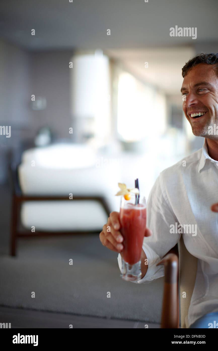 Man holding a cocktail in a hotel lounge, Ramatuelle, Provence-Alpes ...