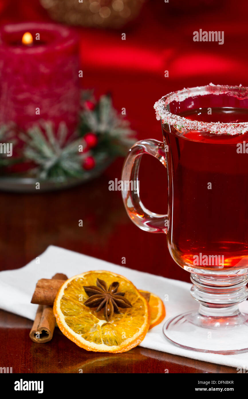 christmas morning tea served in a tall clear glass with spices and a ...