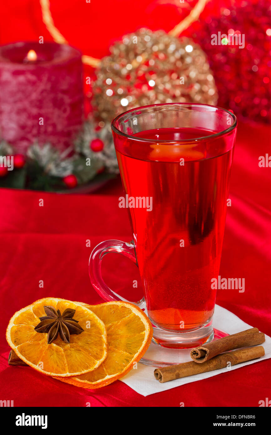 christmas morning tea served in a tall clear glass with spices and a ...