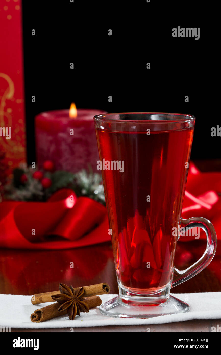 christmas morning tea served in a tall clear glass with spices and a ...