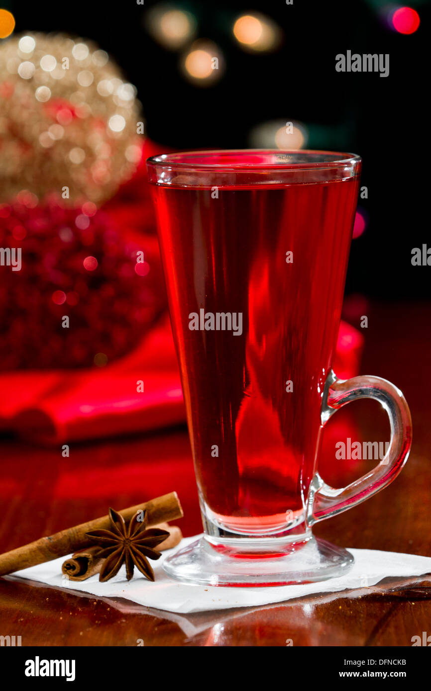 christmas morning tea served in a tall clear glass with spices and a ...