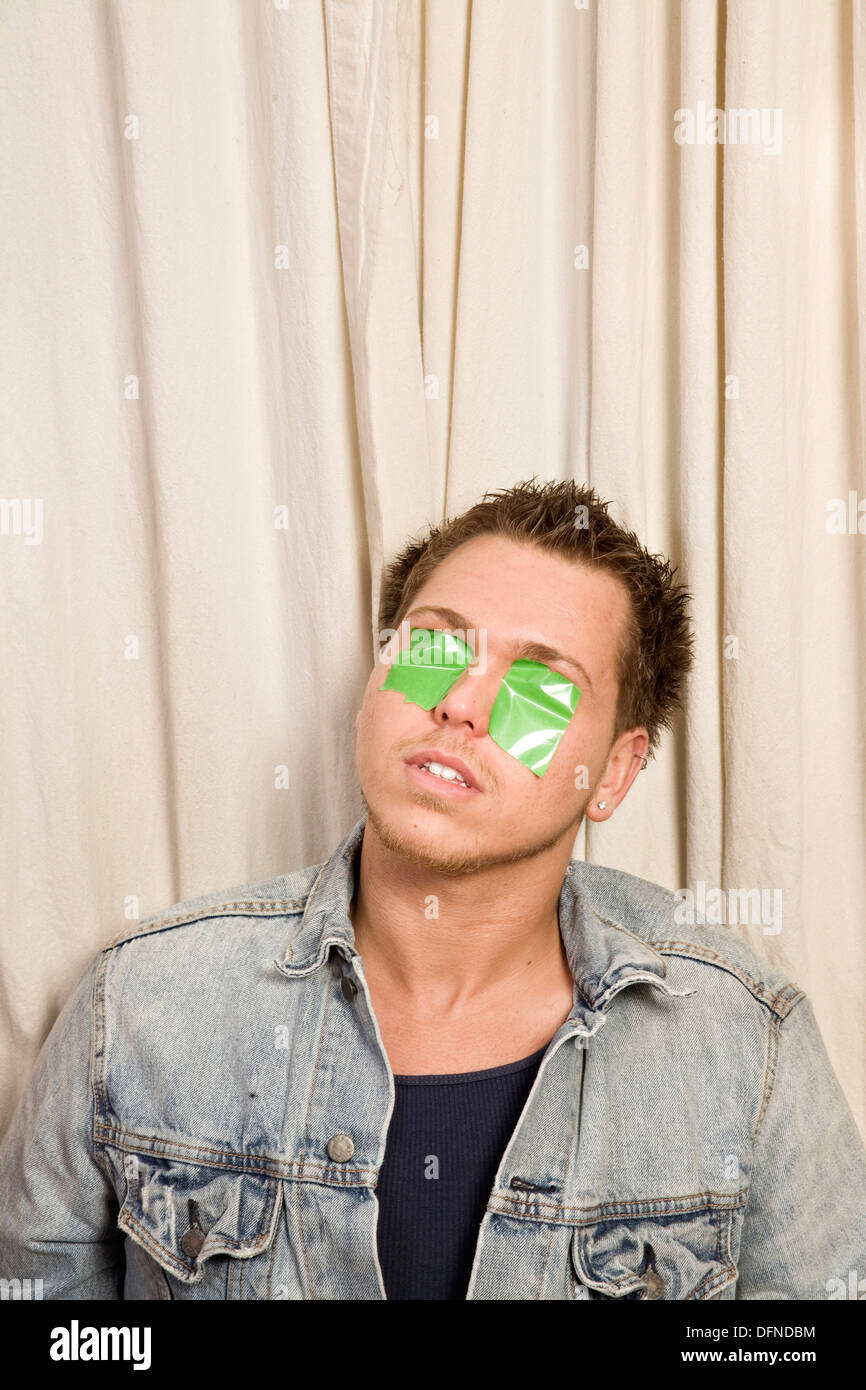 Portrait male covering eyes tape hi-res stock photography and images ...