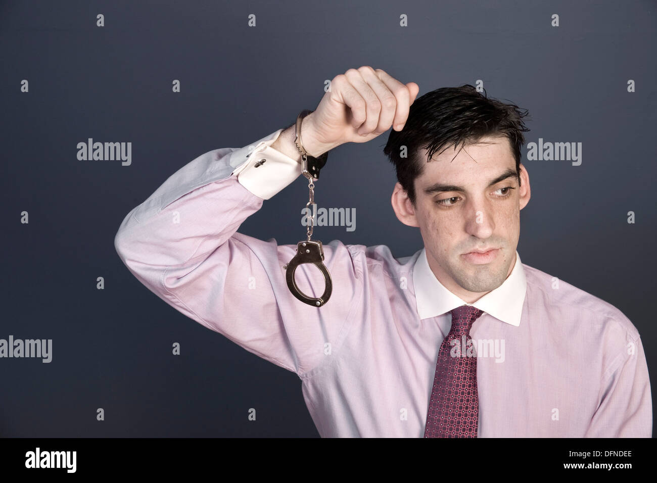 Man wearing handcuffs on one wrist Stock Photo - Alamy