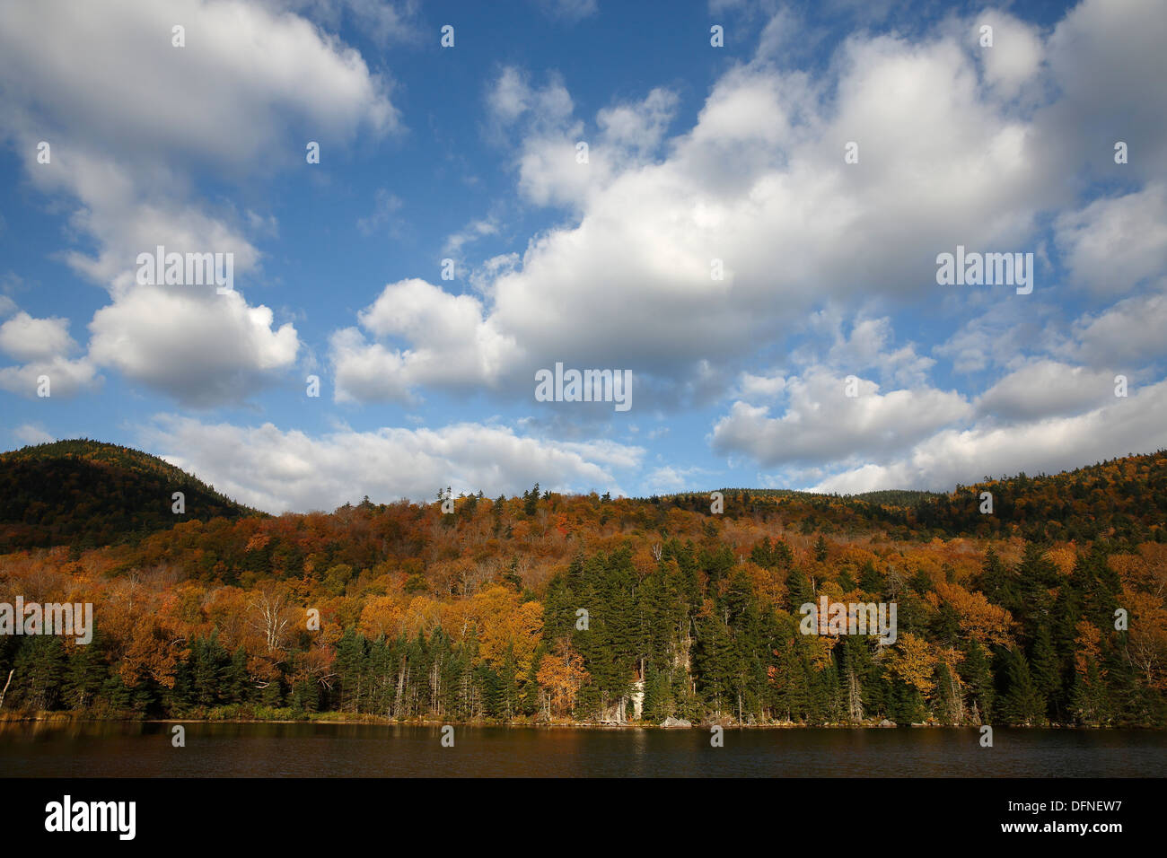 Fall foliage is reflected on the surface of Saco Lake in Crawford Notch ...