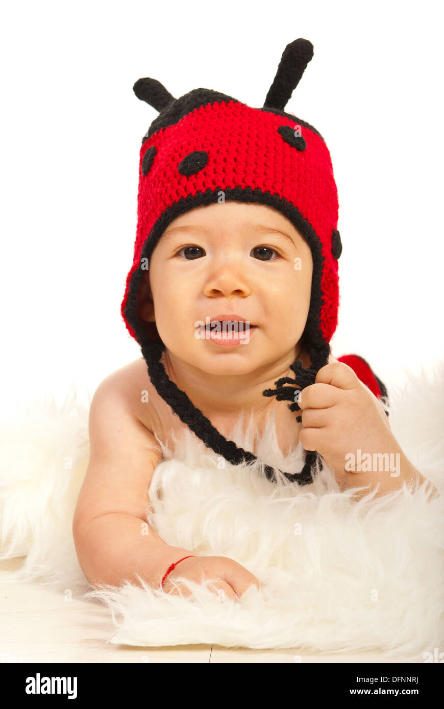 Beauty ladybug baby laying on fur blanket against white background ...