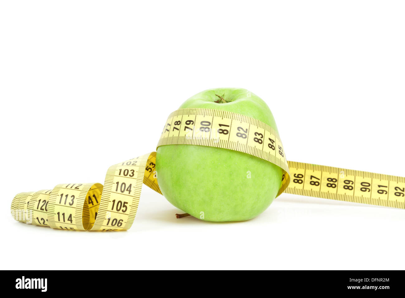 Green apple and yellow measuring tape isolated on white background ...
