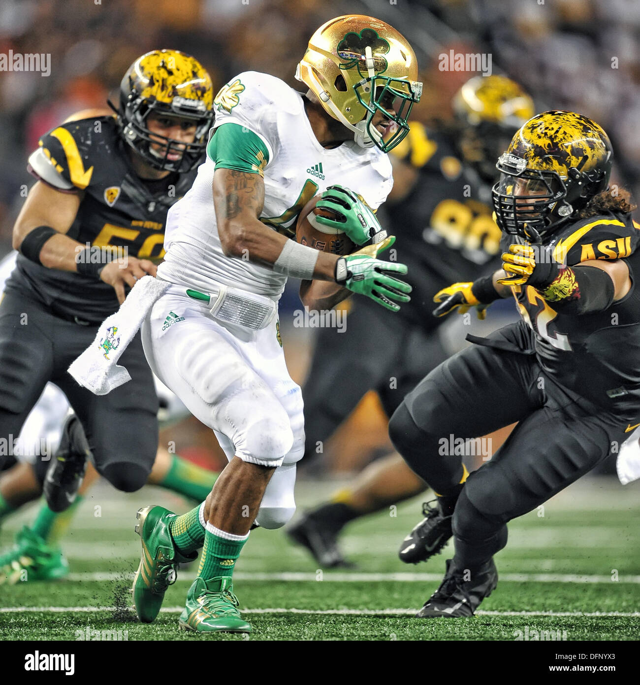 Notre Dame Fighting Irish running back George Atkinson III (4) carries the ball as he is ...