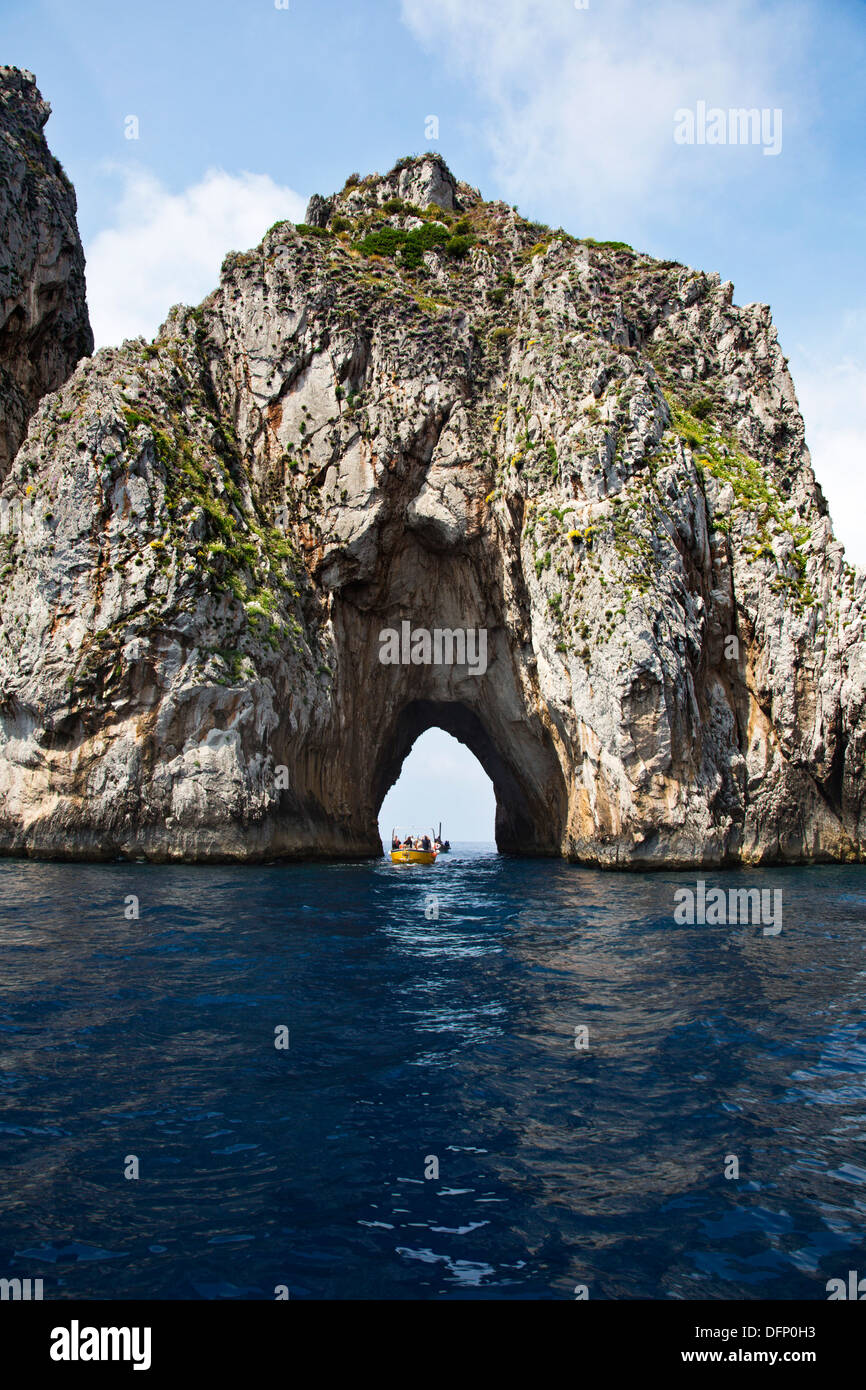 Boat passing through a natural arch, Capri, Naples Province, Campania ...