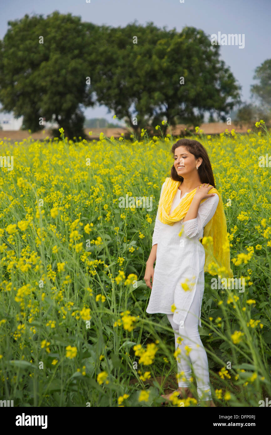 Woman standing in mustard field hi-res stock photography and images - Alamy